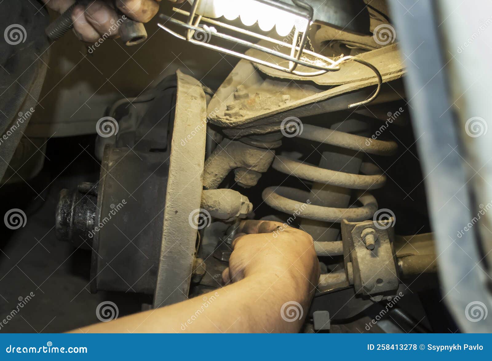 A Man Repairs a Car. Repair of the Machine. the Hand of the Machine is ...