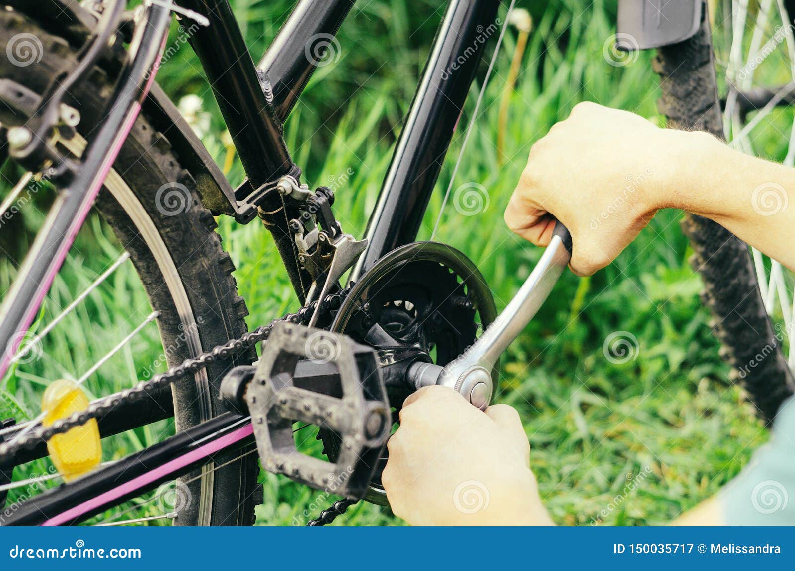 A Man Repairs a Chain on a Mountain Bike with a Socket Wrench on the ...