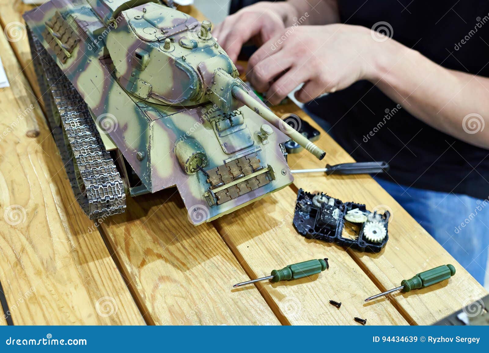 Man Repairs a Reduced Model of Soviet Tank T-34 Stock Image - Image of ...