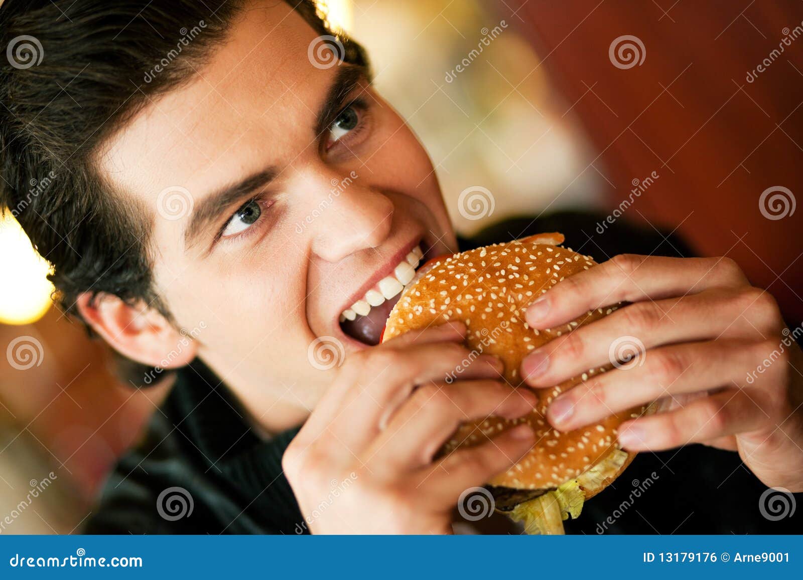Man in Restaurant Eating Hamburger Stock Photo - Image of fast, junk ...
