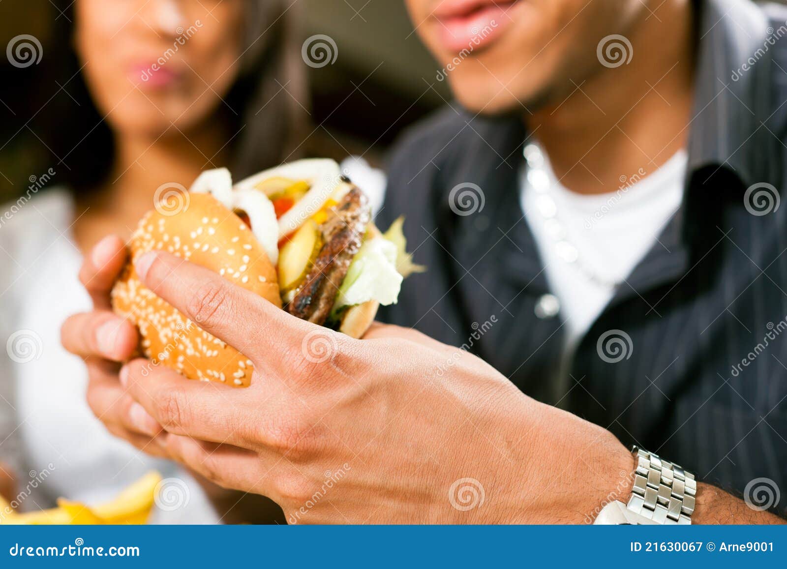 Man in a Restaurant Eating Hamburger Stock Image - Image of ...