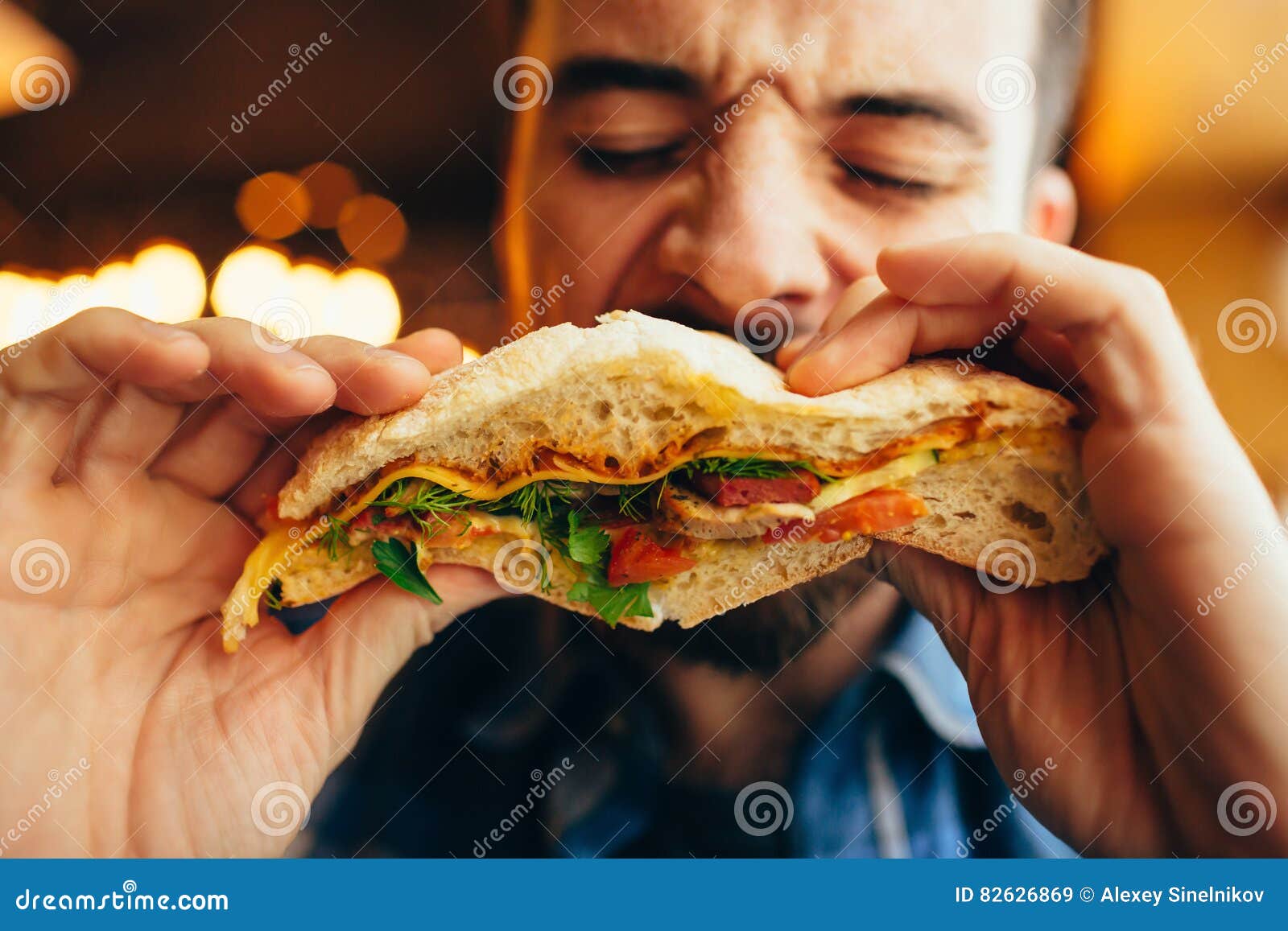 Man in a Restaurant Eating a Hamburger Stock Image - Image of checkered ...
