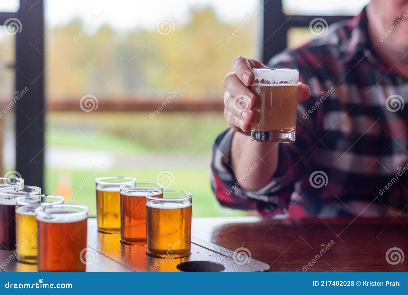 Man at a Restaurant Sampling Beer from a Beer Flight Stock Photo ...