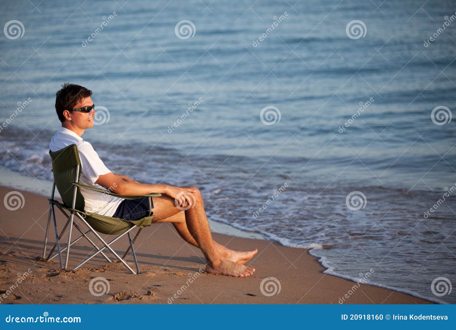 Man resting on the beach stock photo. Image of calmness - 20918160