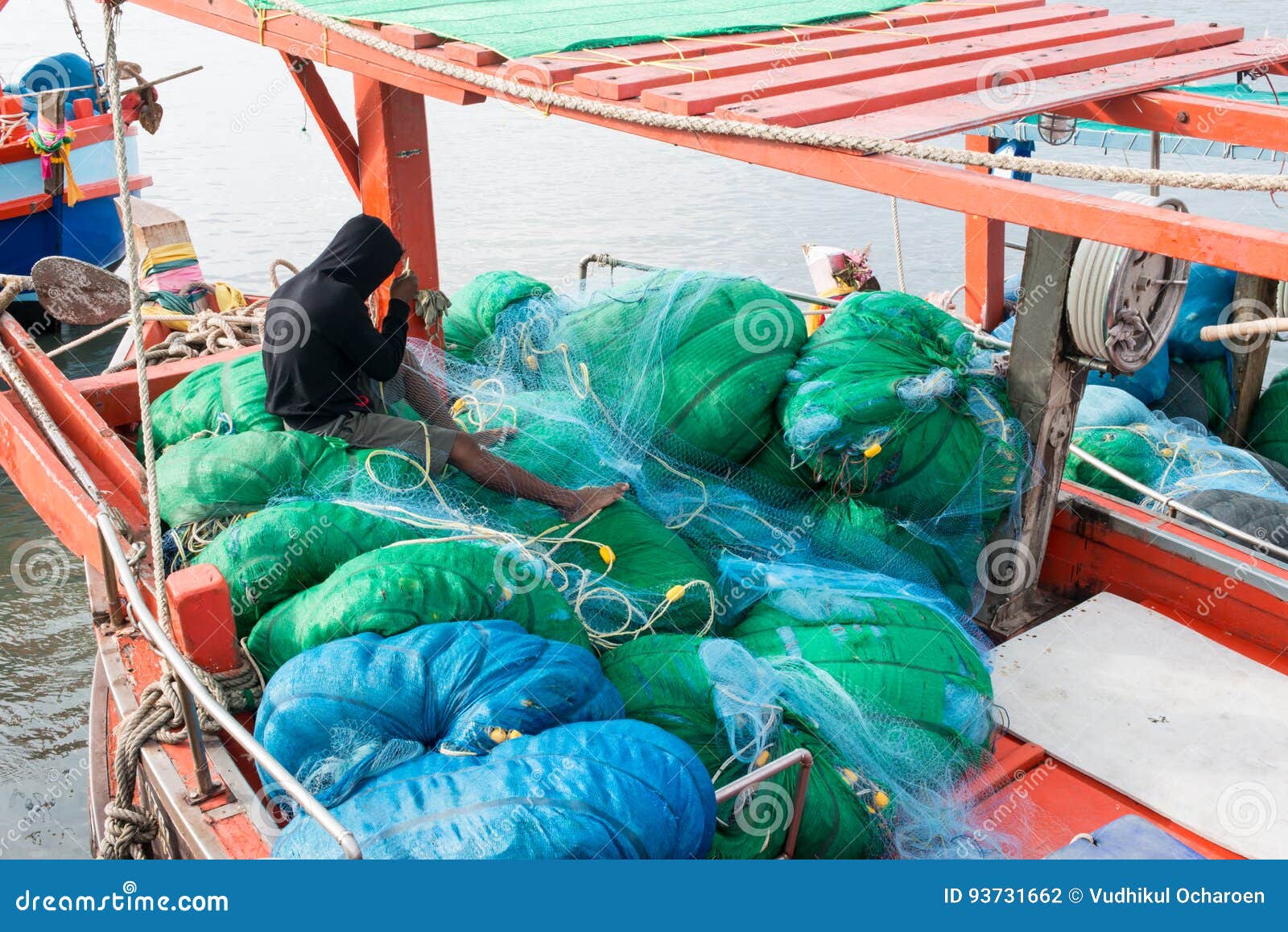A Man Resting on Fishing Net Stock Photo - Image of maritime, fisherman ...