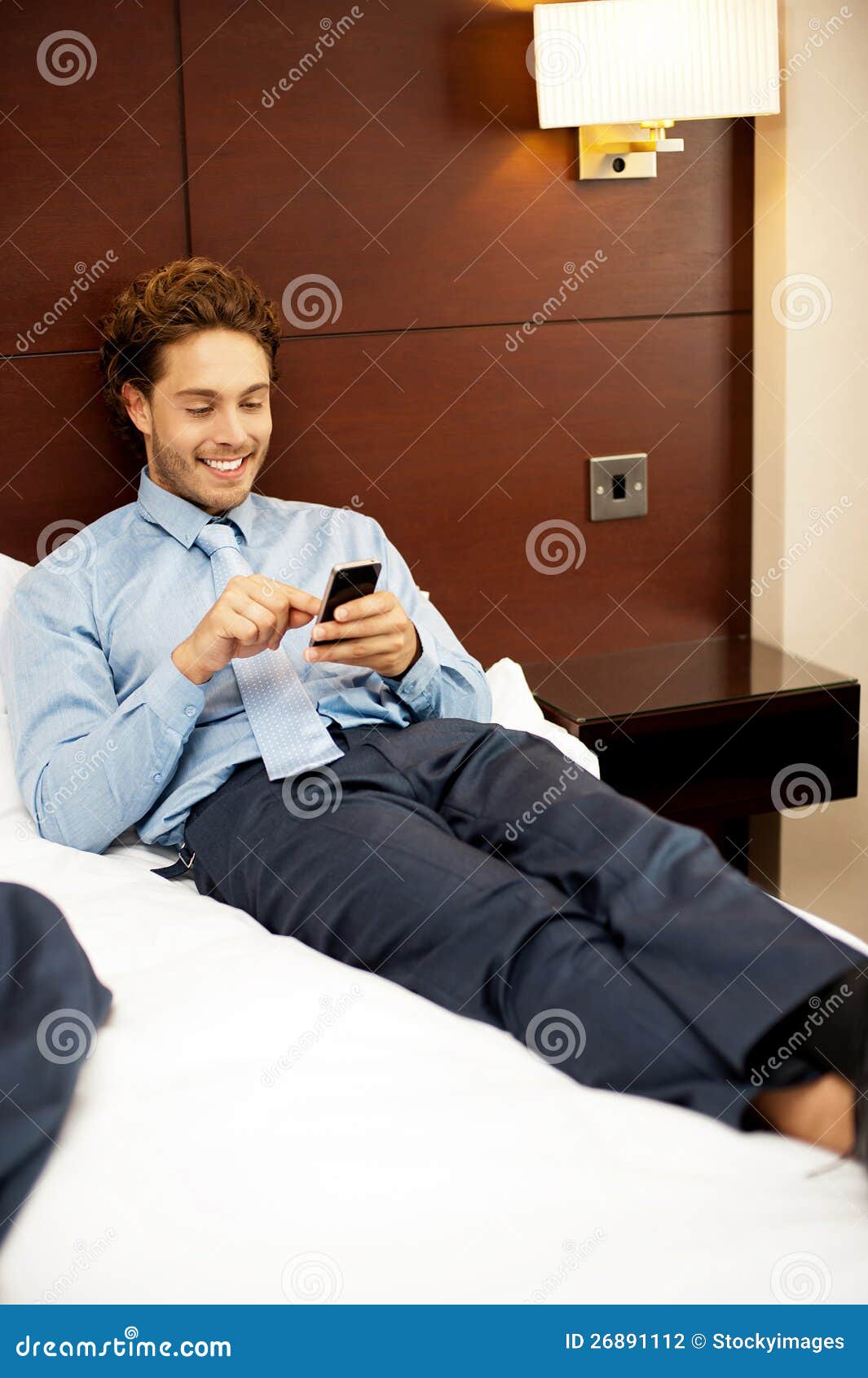 Man Resting in Luxurious Bed and Messaging Stock Photo - Image of hotel ...