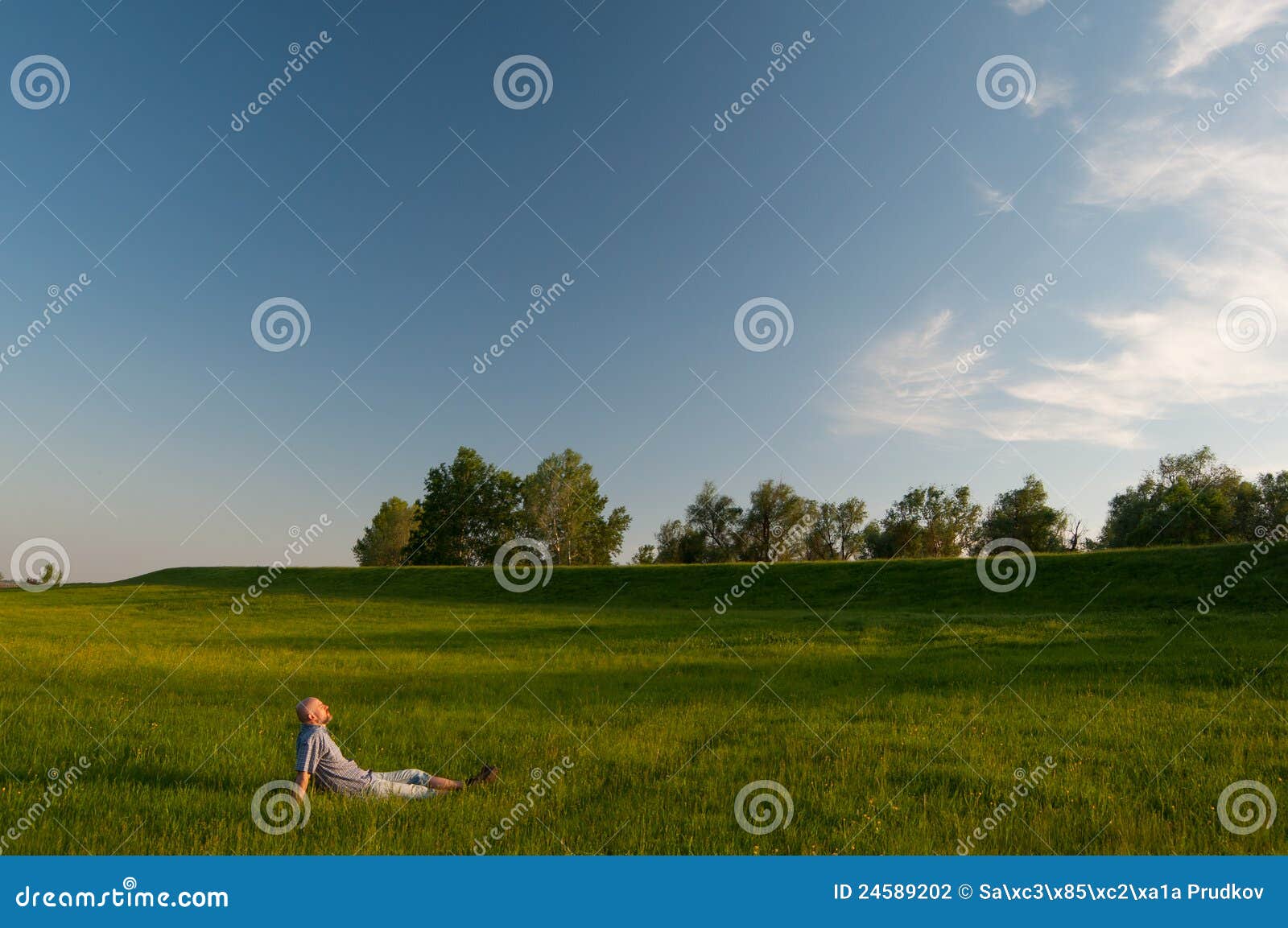 Man Resting in the Middle of Huge Meadow Stock Photo - Image of lying ...