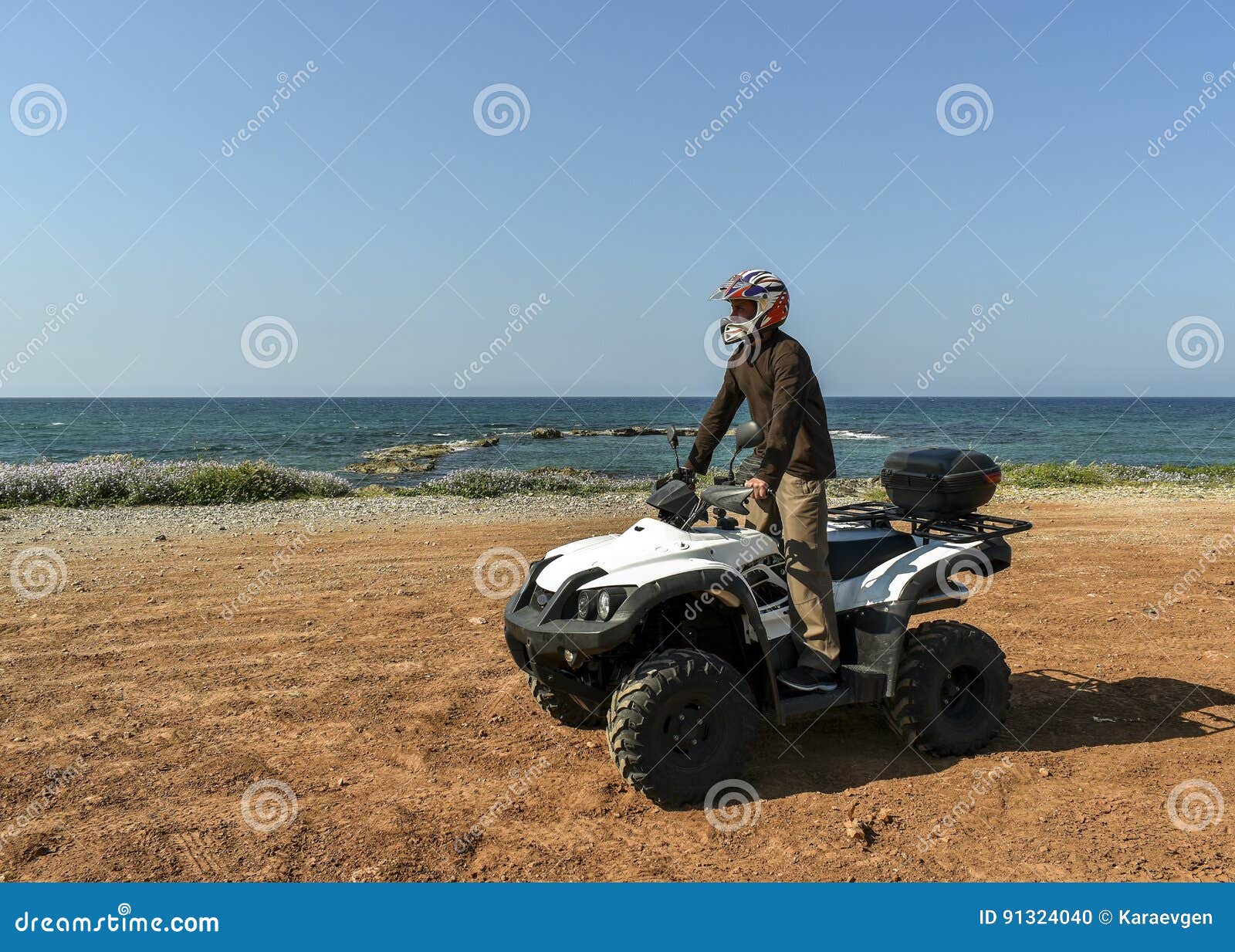 A Man Riding ATV in Sand in a Helmet. Stock Photo - Image of cross ...