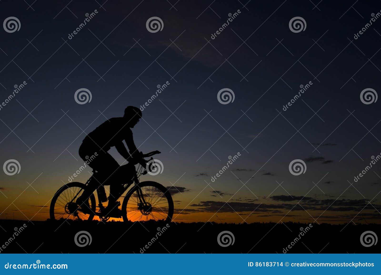 Man Riding Bicycle During Nightfall Picture. Image: 86183714