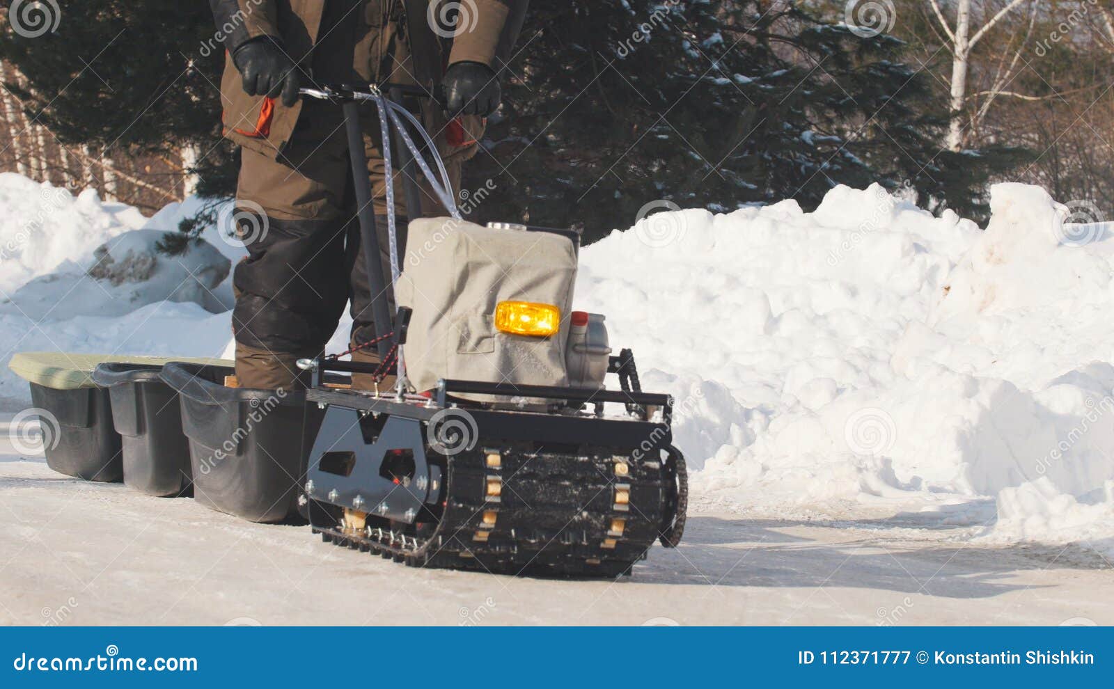 Man Riding on Crawler Mini Snowmobile with a Trailer and a Passenger on ... Man Riding on Crawler Mini Snowmobile with a Trailer and a Passenger on ...