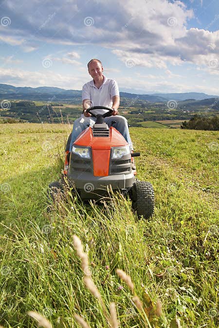 Man riding a lawn tractor stock image. Image of grass - 25752681