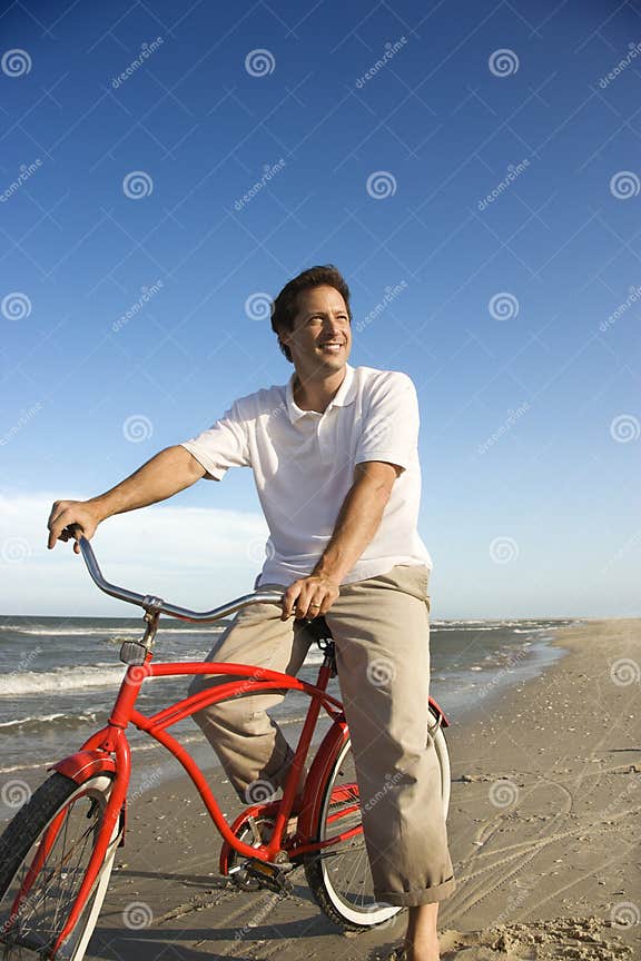 Man Riding Red Bicycle on Beach. Stock Image - Image of colour, color ...