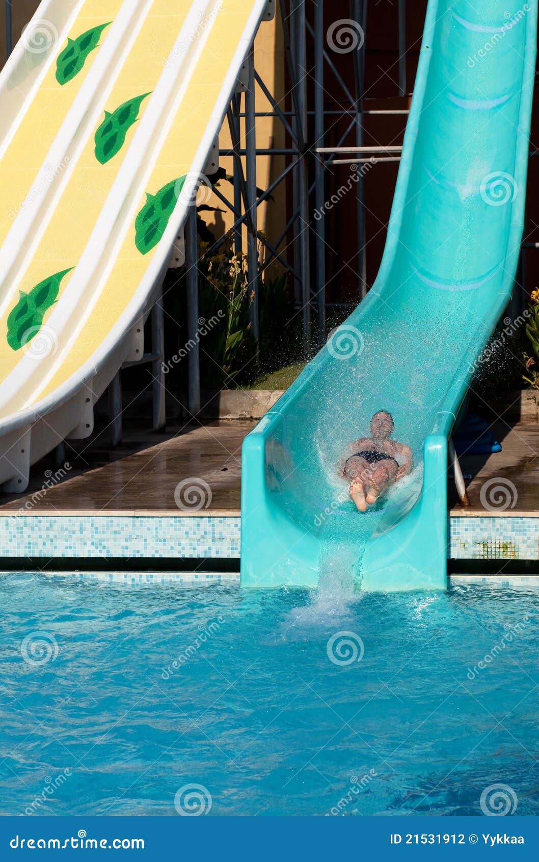 Man riding a water slide stock photo. Image of slide - 21531912