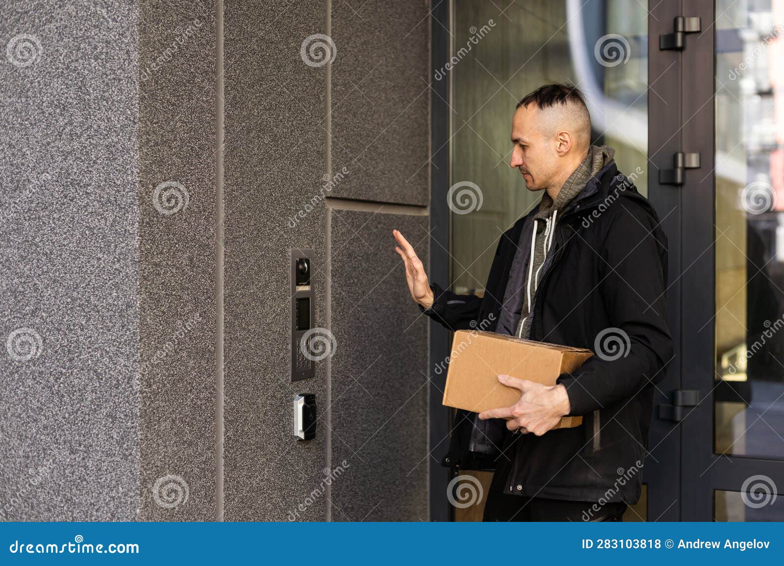 Man Ringing Intercom with Camera Near Building Entrance. Stock Photo ...