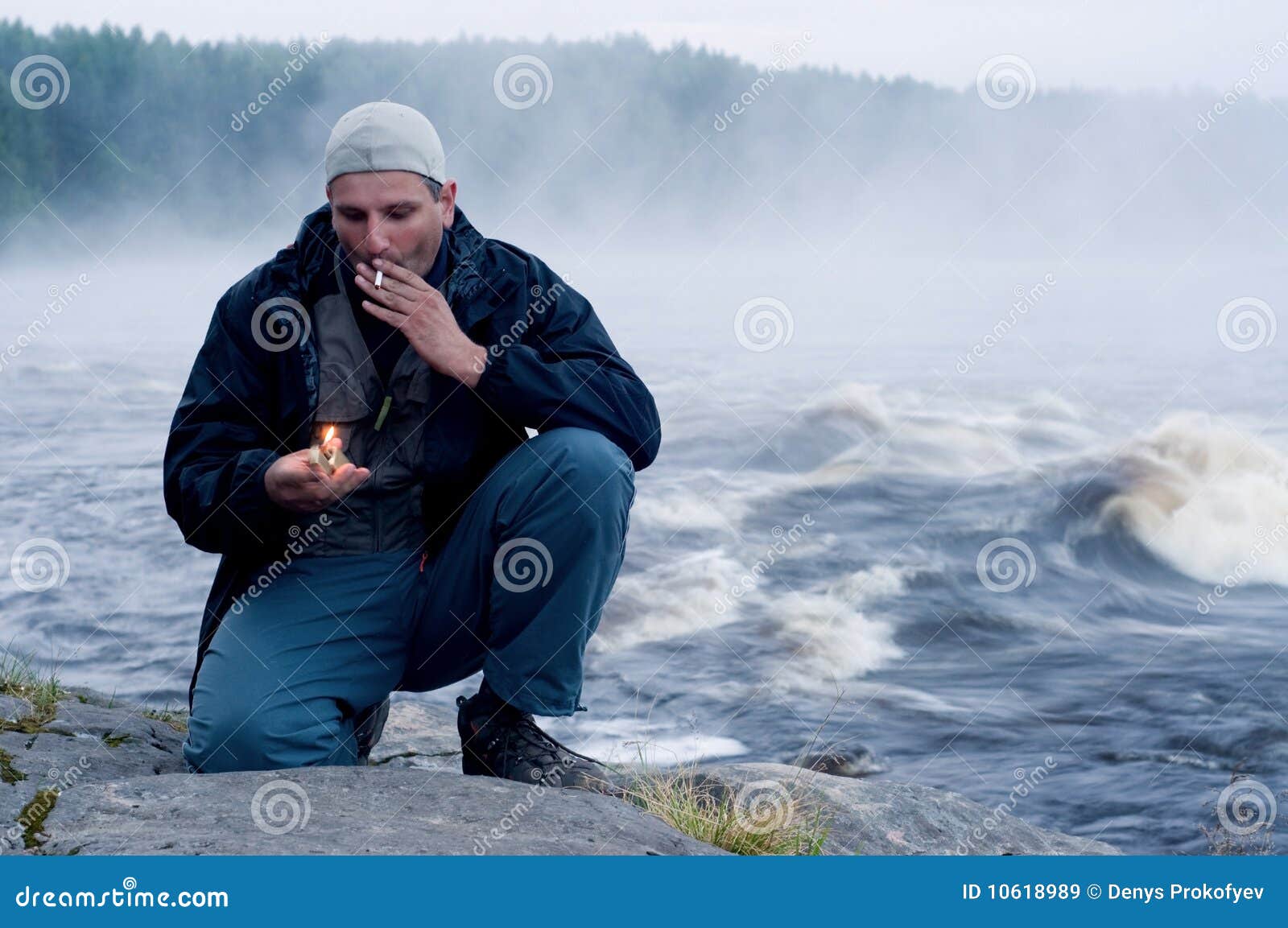 Man on river bank stock image. Image of rock, sitting - 10618989
