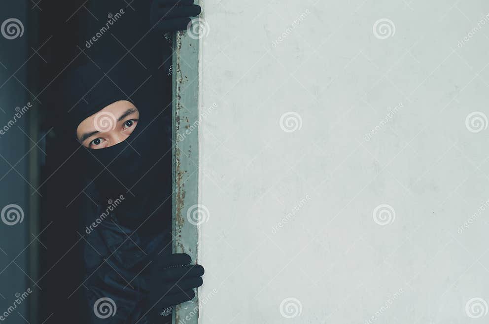Man Robber,Thief in Mask Hiding Behind a Empty Wall with Space for Text ...