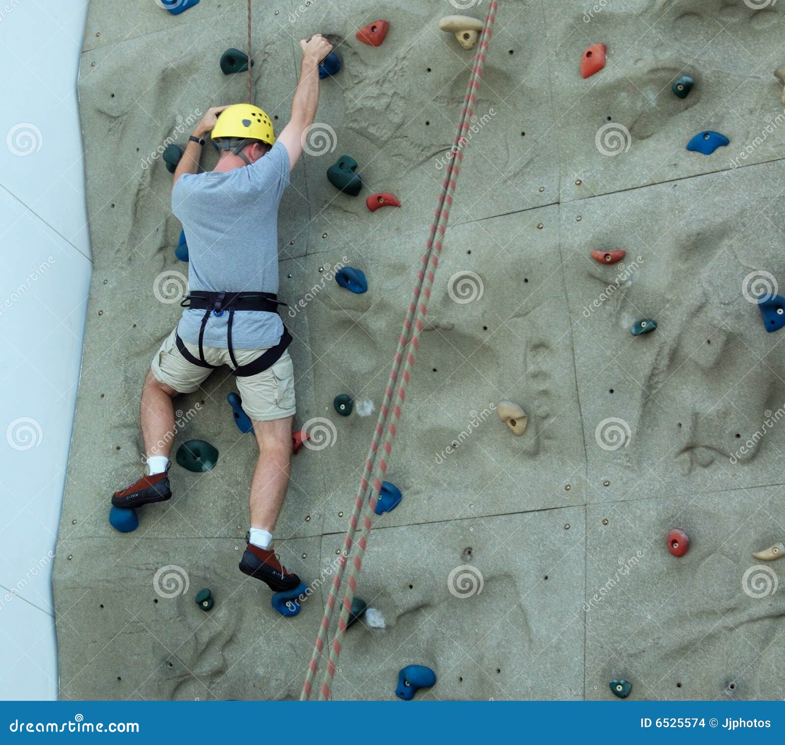 Caucasian Man Bouldering with Safety Harness and Helmet Stock Photo ...