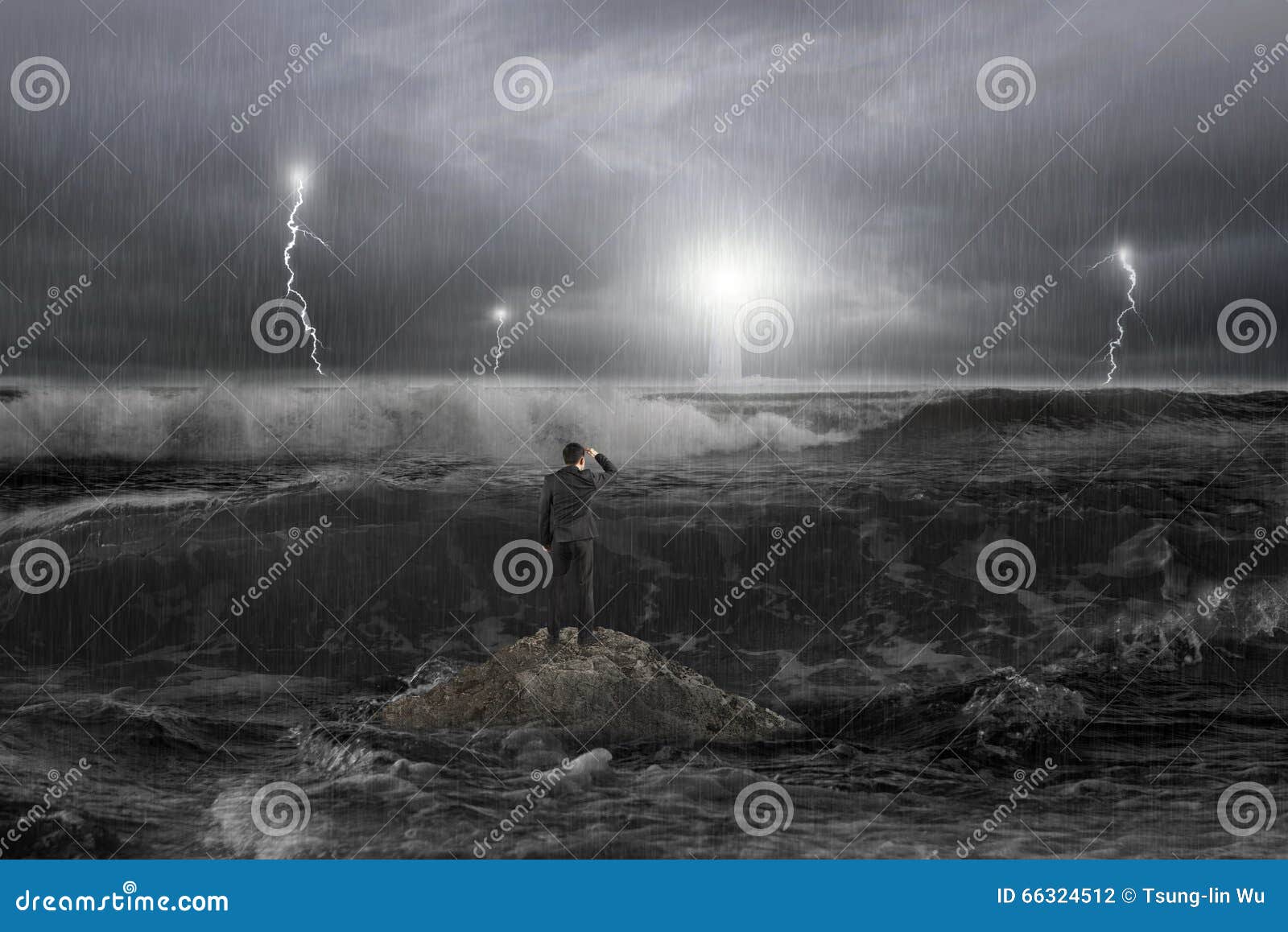 Man on Rock Gazing Lighthouse in the Ocean with Storm Stock Photo ...
