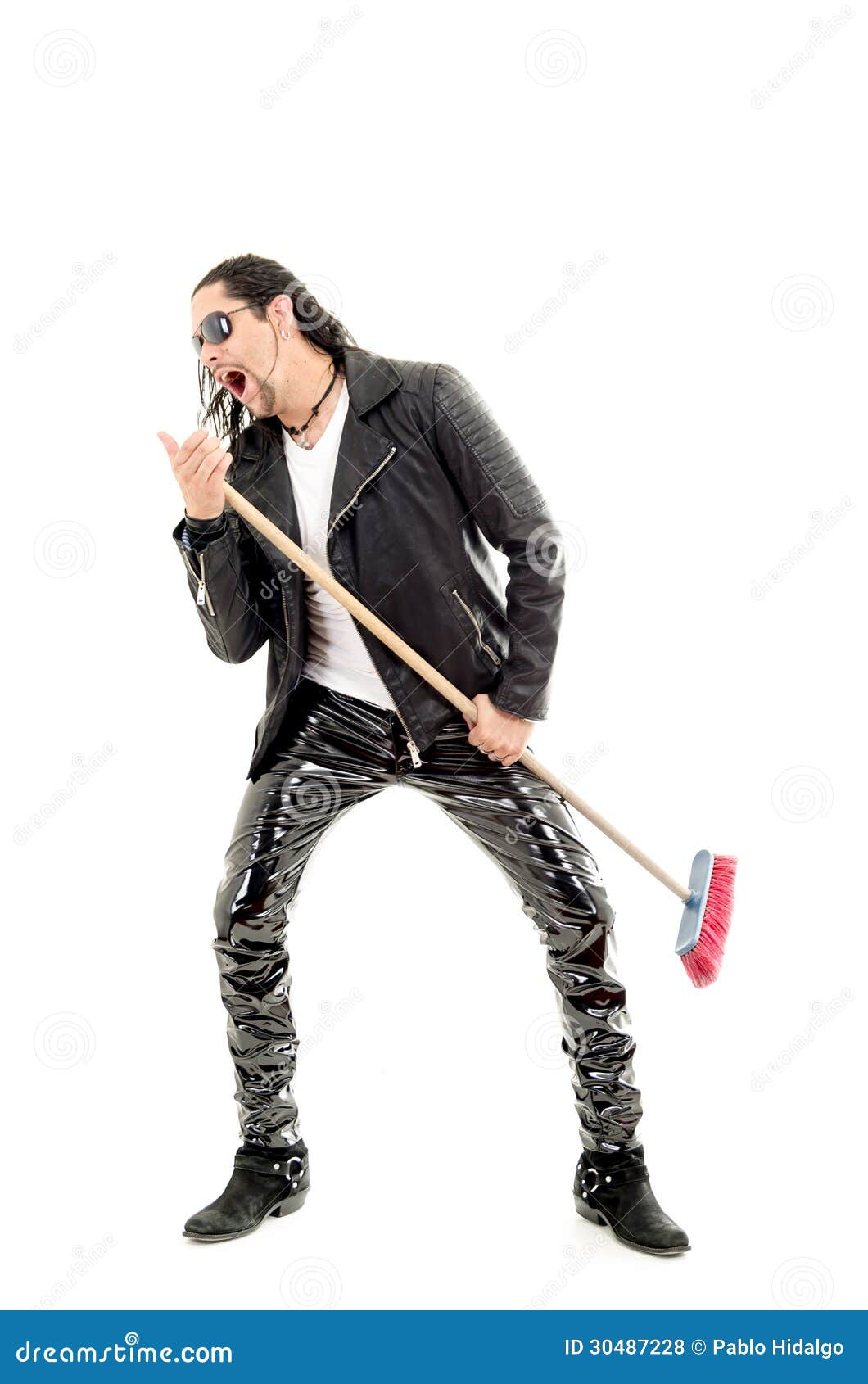 Man Rocking Out with broom stock photo. Image of performing - 30487228