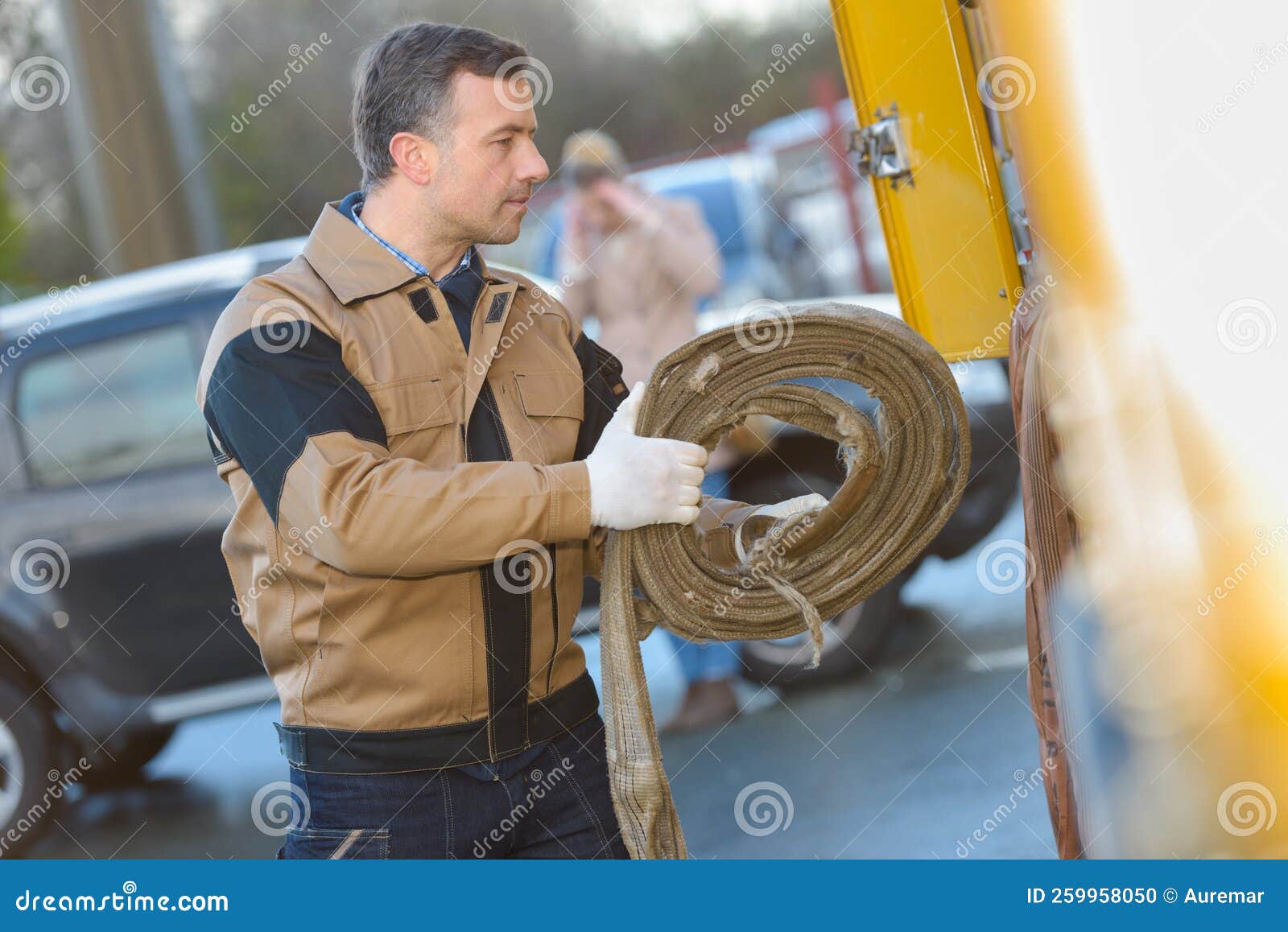 Man with rolled hose reel stock photo. Image of unloading - 259958050