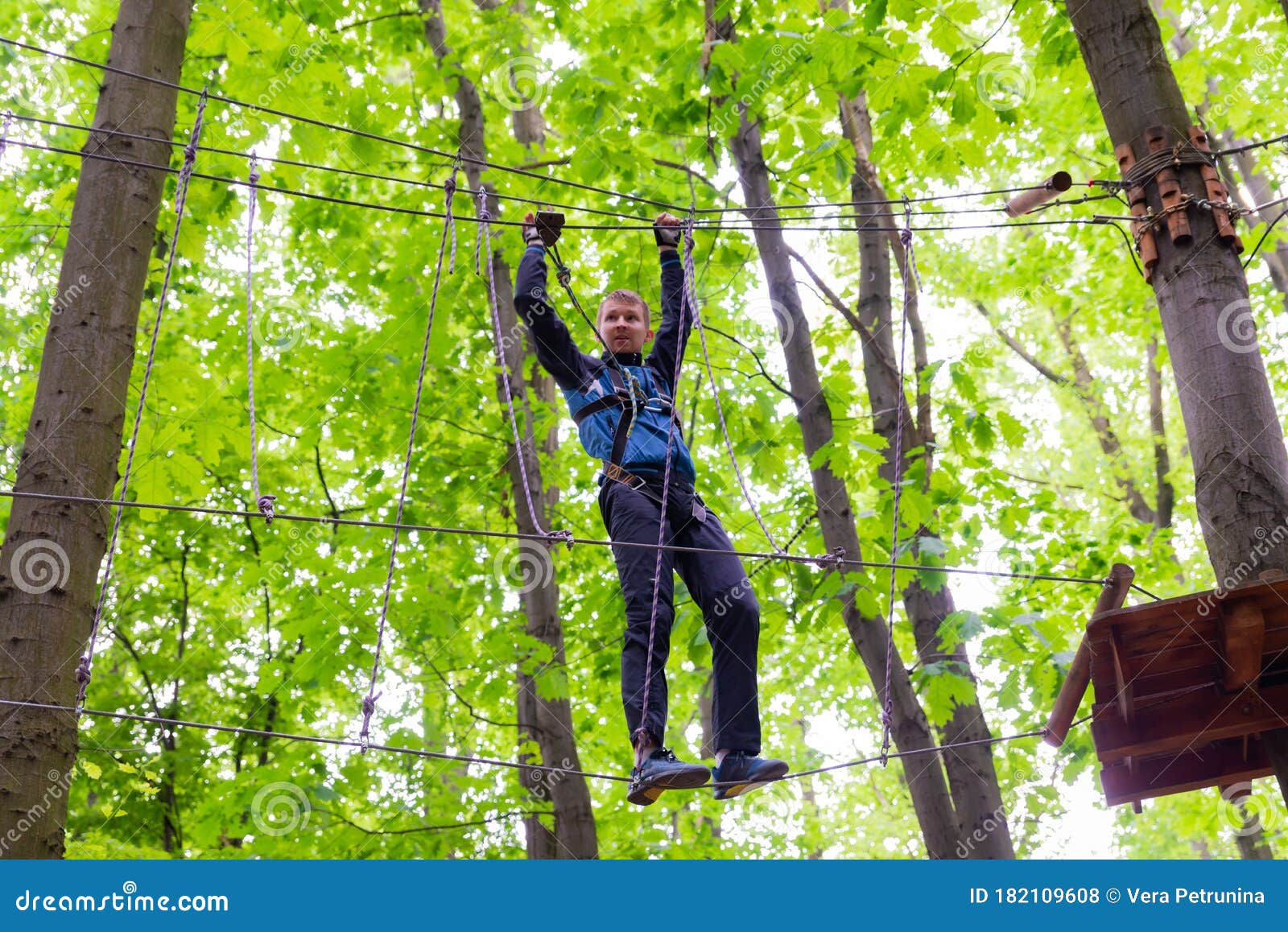 Man at rope park in forest stock photo. Image of high - 182109608