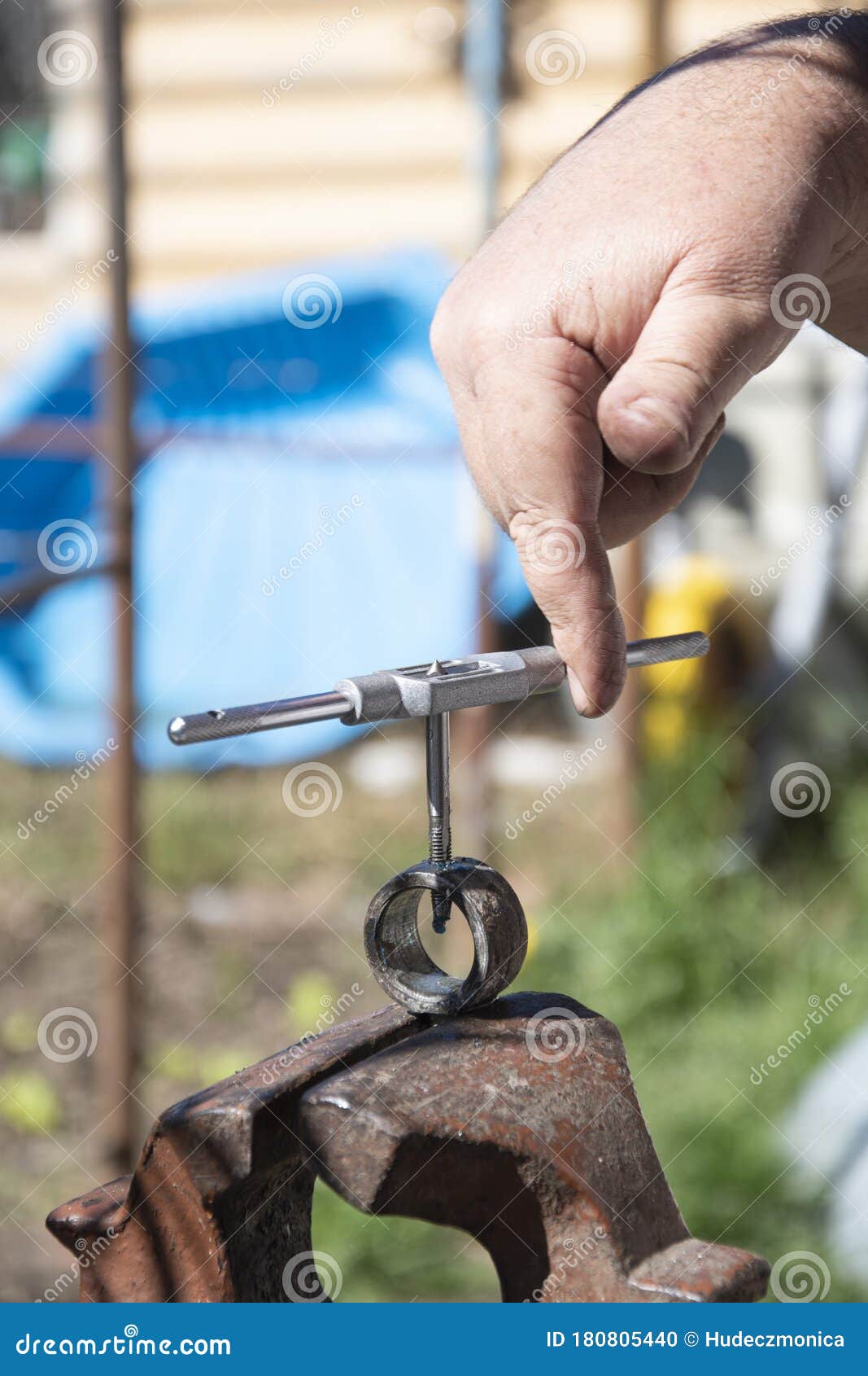 Man Rotating the Thread Cutting Tool in an Iron Ring, Outdoor Stock ...