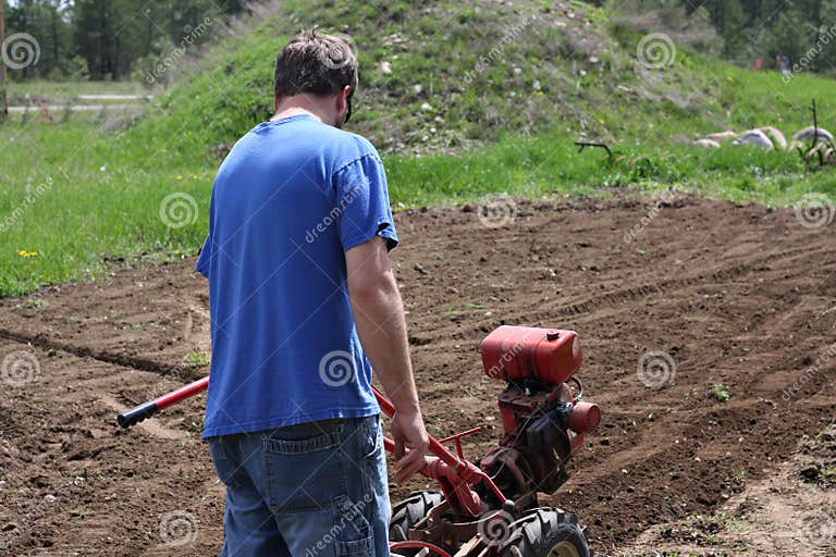 Man rototilling garden. stock photo. Image of dirt, soil - 10130692