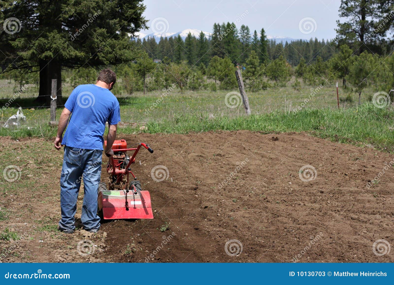 Man rototilling garden. stock image. Image of nature - 10130703