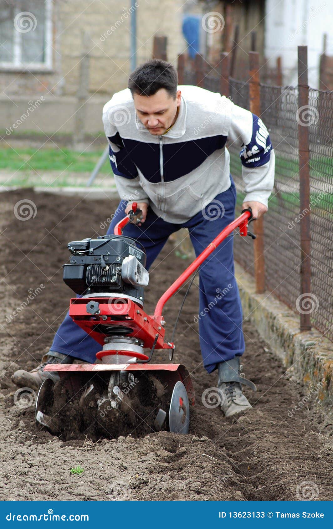 Man rototilling garden. stock image. Image of construction - 13623133