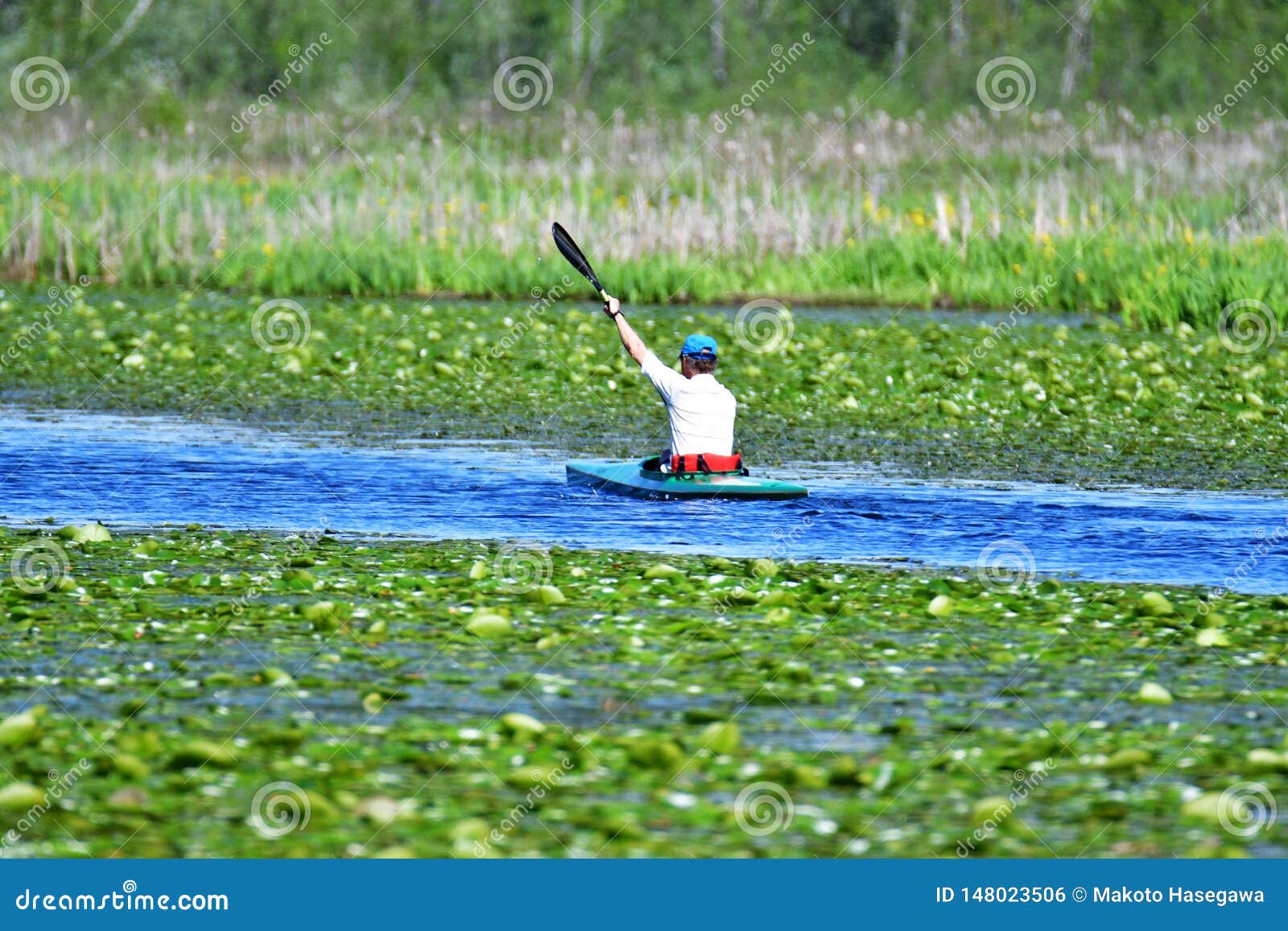 A Man is Rowing Along the Lake on a Kayak. Stock Photo - Image of ...