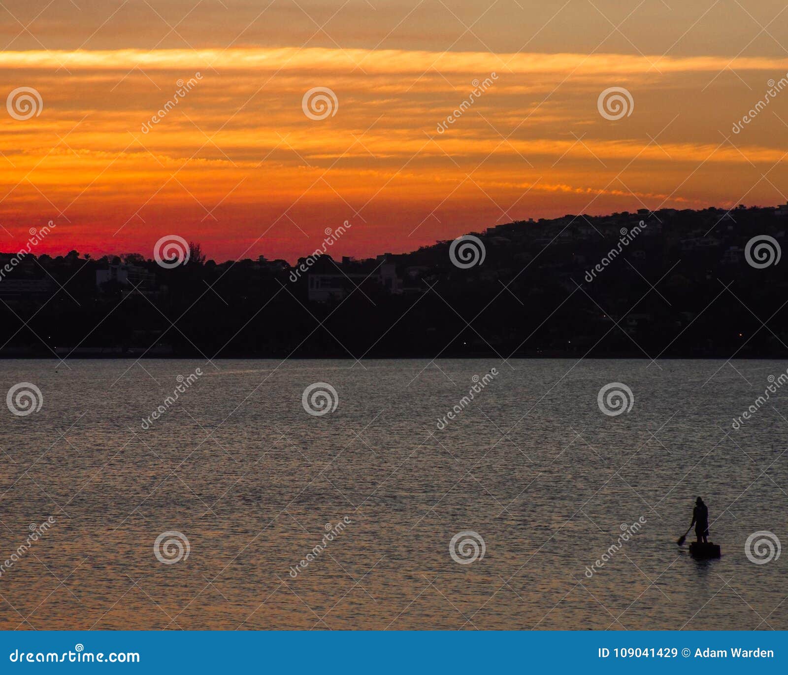 Man Rowing Boat at Sunset stock image. Image of skies - 109041429