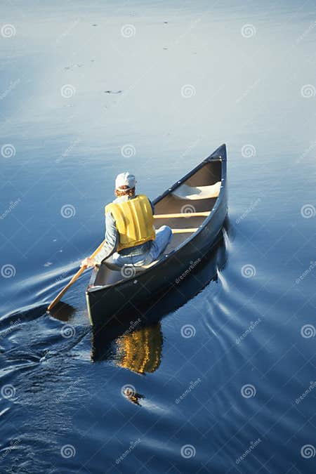 Man rowing a canoe editorial stock photo. Image of leaves - 23148458