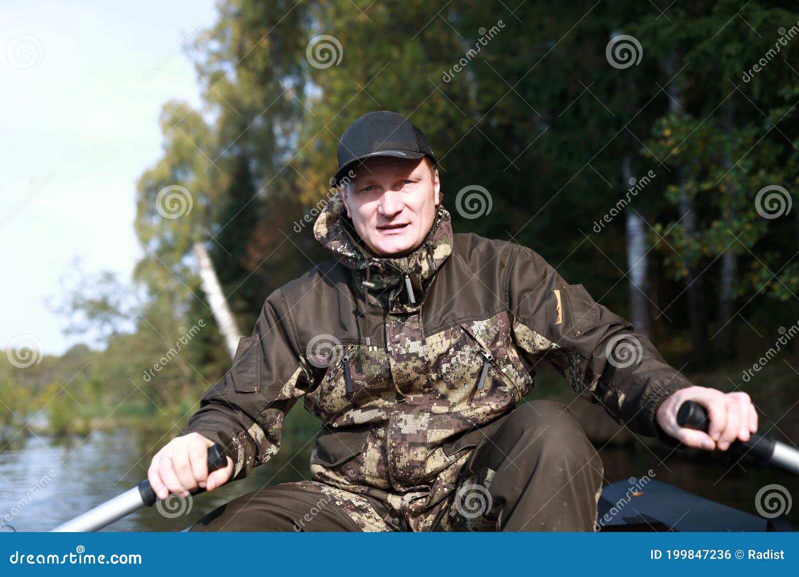 Man rowing oars on boat stock photo. Image of activity - 199847236