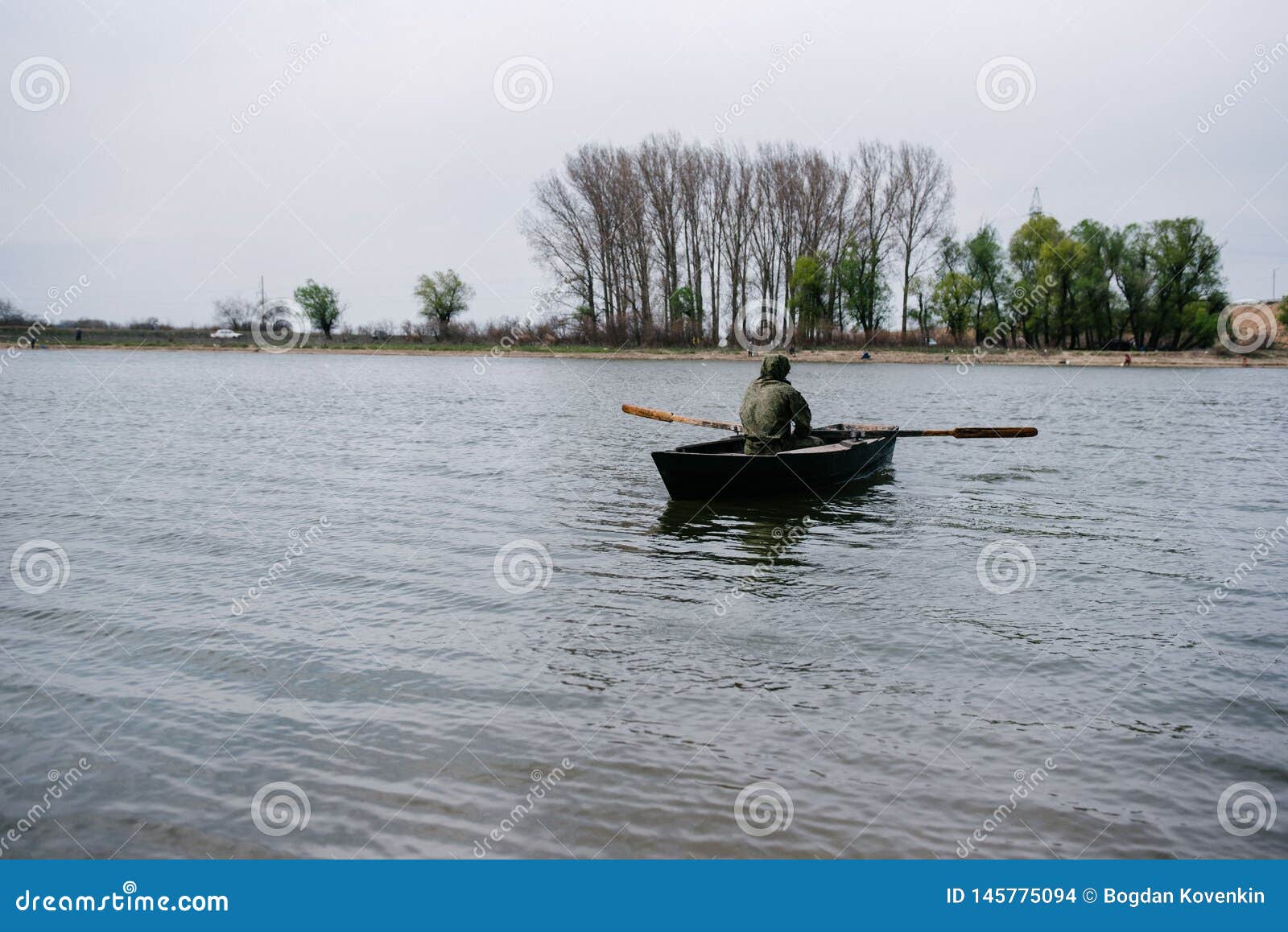 A Man is Rowing in a Wooden Boat Stock Photo - Image of small, adult ...