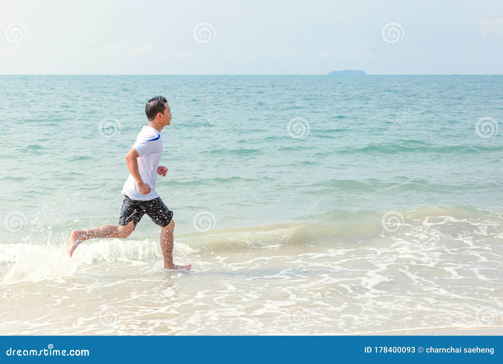 A man runing on the beach stock image. Image of mountain - 178400093