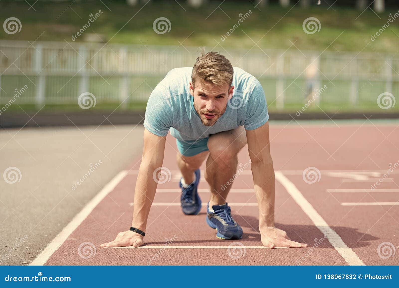 Man Runner on Start Position at Stadium. Runner in Start Pose on ... Man Runner on Start Position at Stadium. Runner in Start Pose on ...