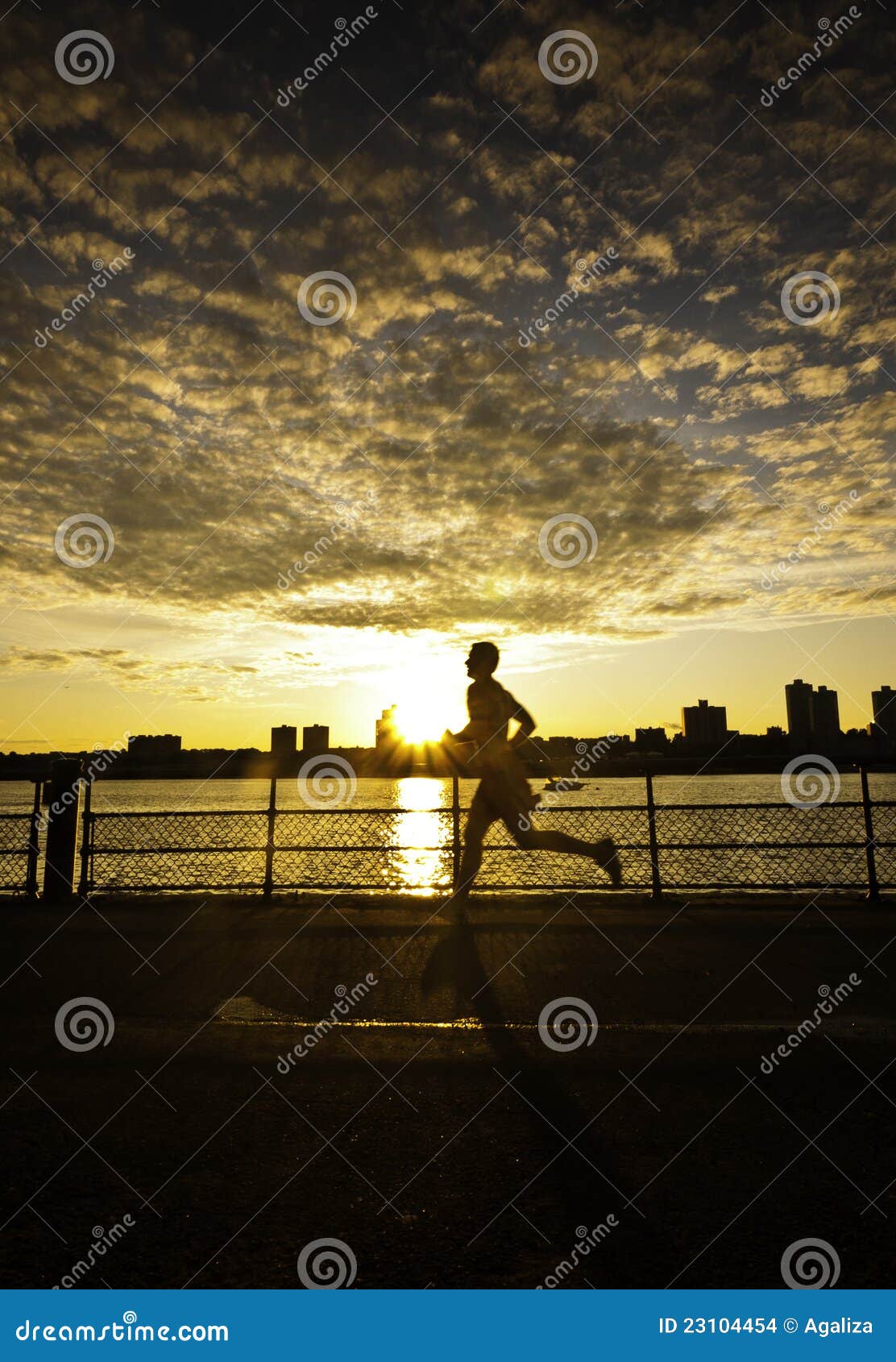 Man Running Along River at Sunset Stock Photo - Image of silhouetted ...