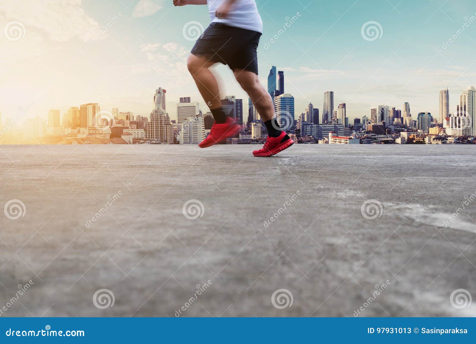 A Man Running on Concrete Road with City View in Sunrise, Selective ...
