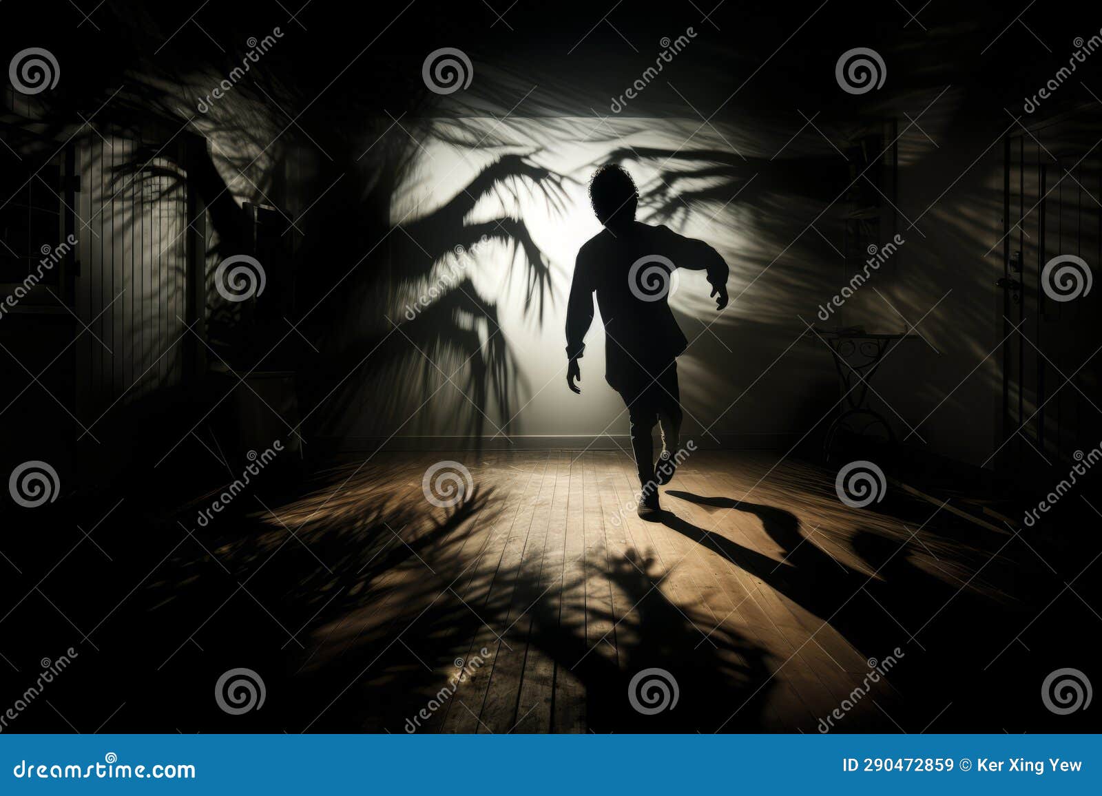 Man Running through a Dark Room in a Dramatic Silhouette Stock ...