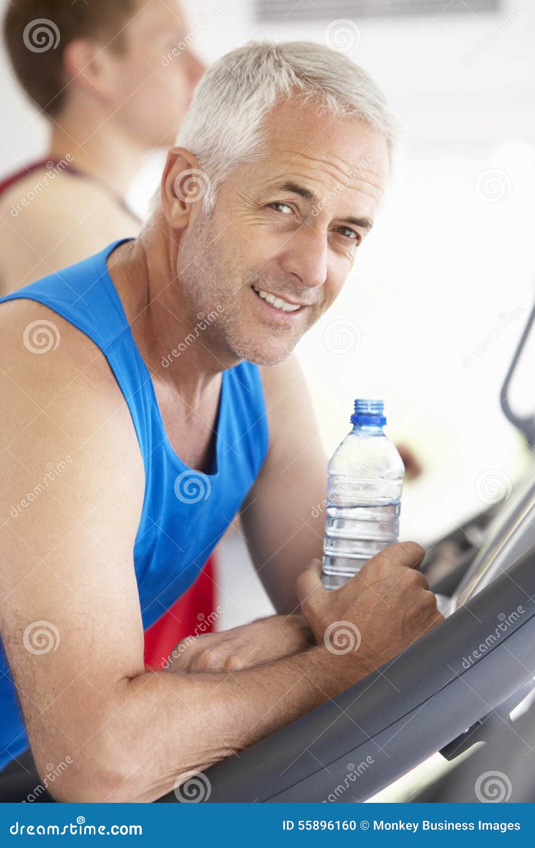 Man on Running Machine in Gym Drinking Water Stock Photo - Image of ...