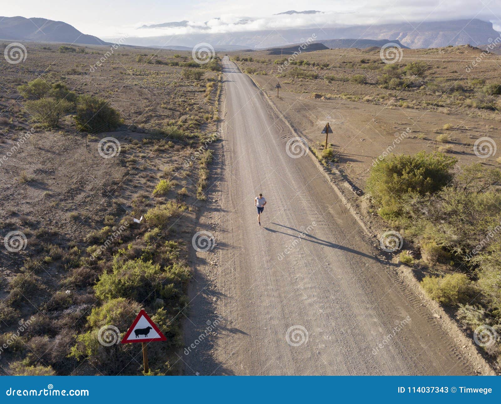 Man Running on an Open Empty Road in Arid Landscape Stock Image - Image ...