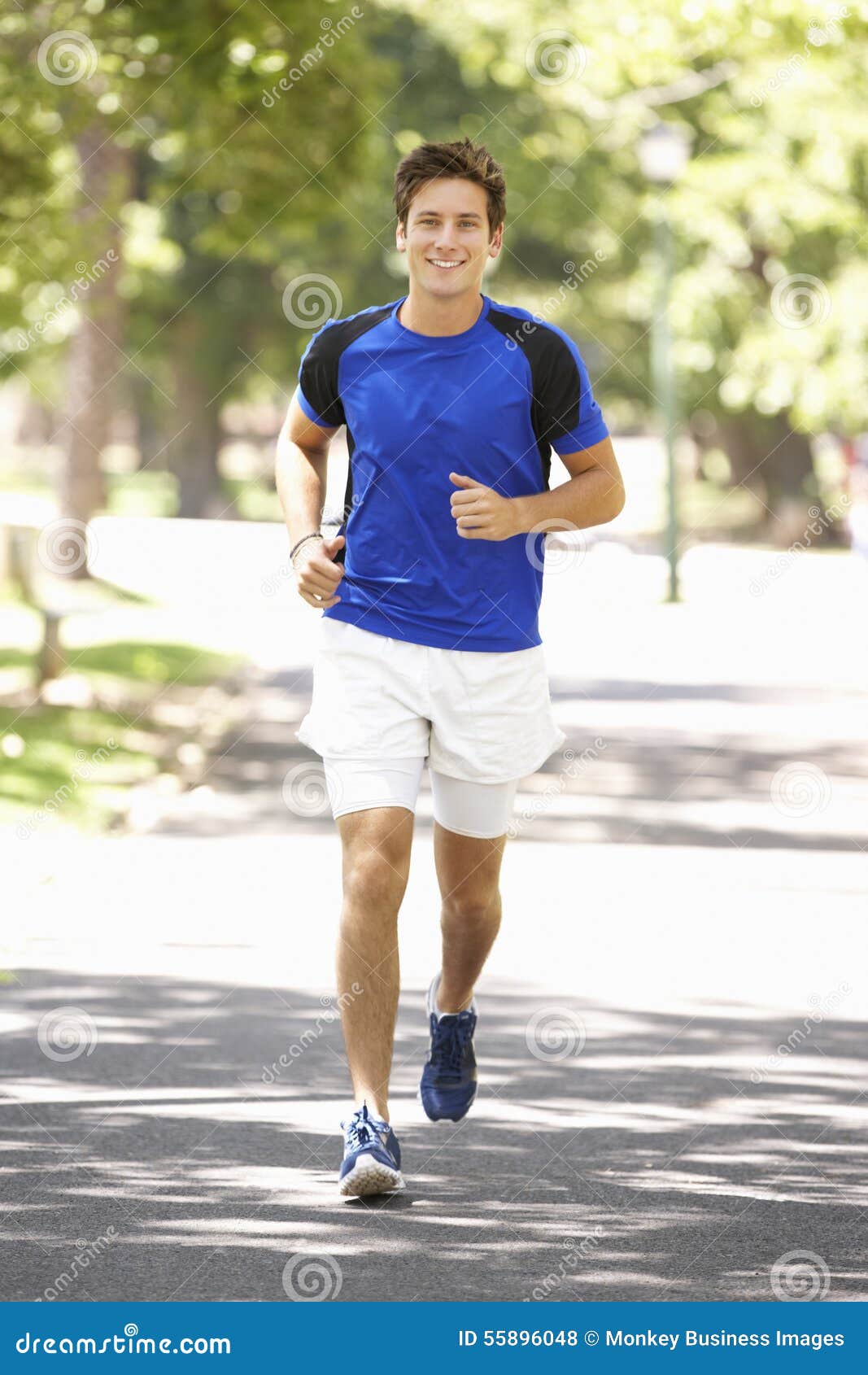 Man Running through Park stock photo. Image of twenties - 55896048