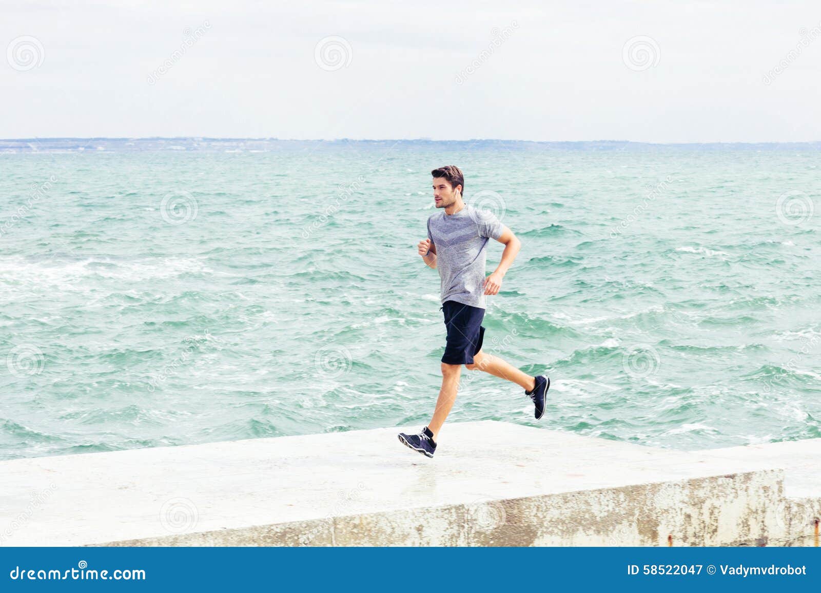 Man Running on the Pier at Beach Stock Image - Image of action, ocean ...