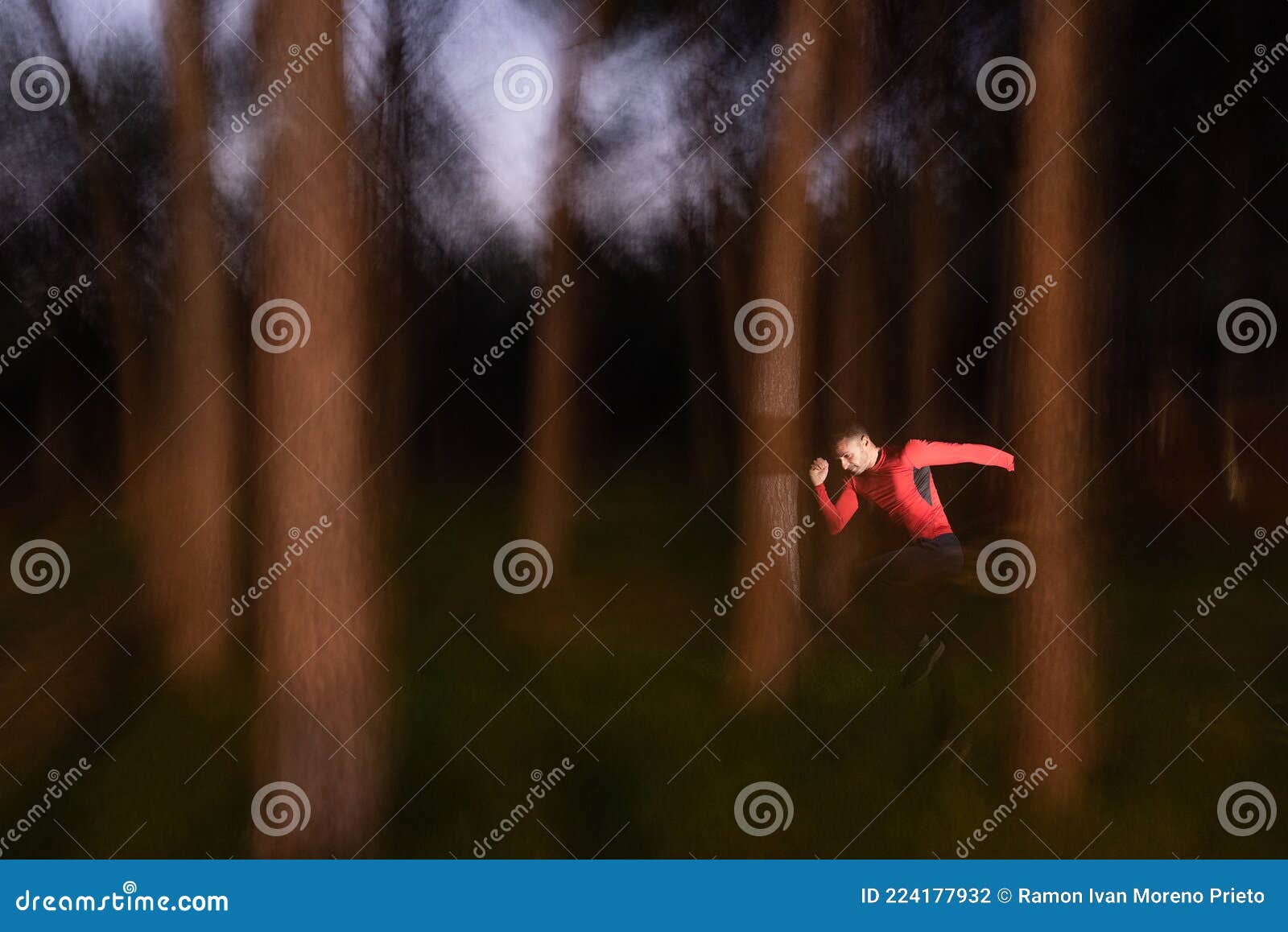 Man Running through the Trees on a Blurred Motion of Forest Stock Photo ...