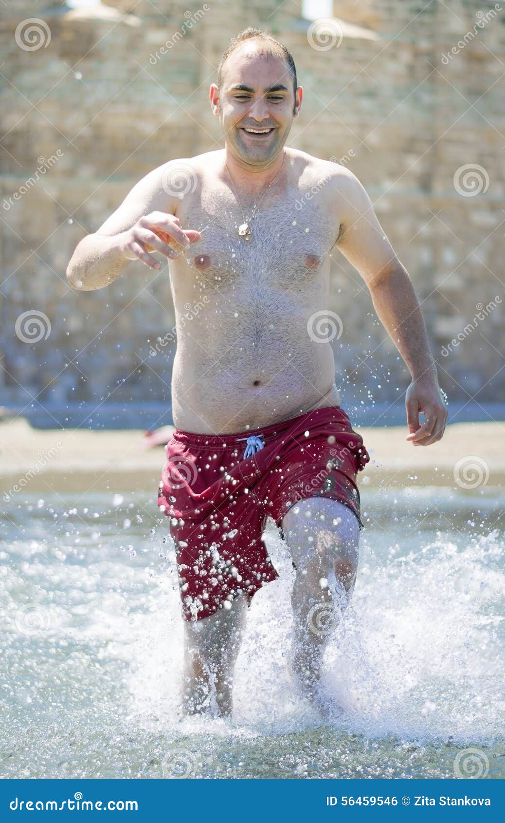 Man running in water stock photo. Image of enjoy, activity - 56459546