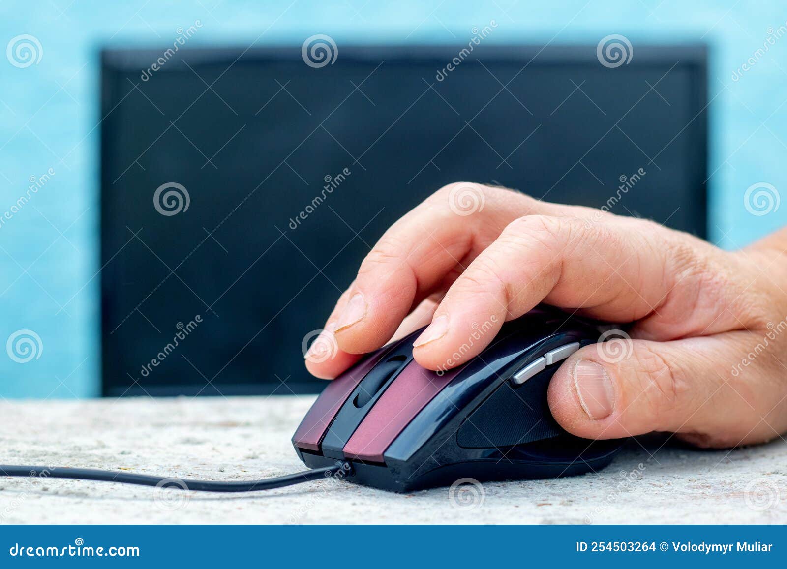 A Man`s Hand on a Computer Mouse Near a Computer. Entering Data on a ...