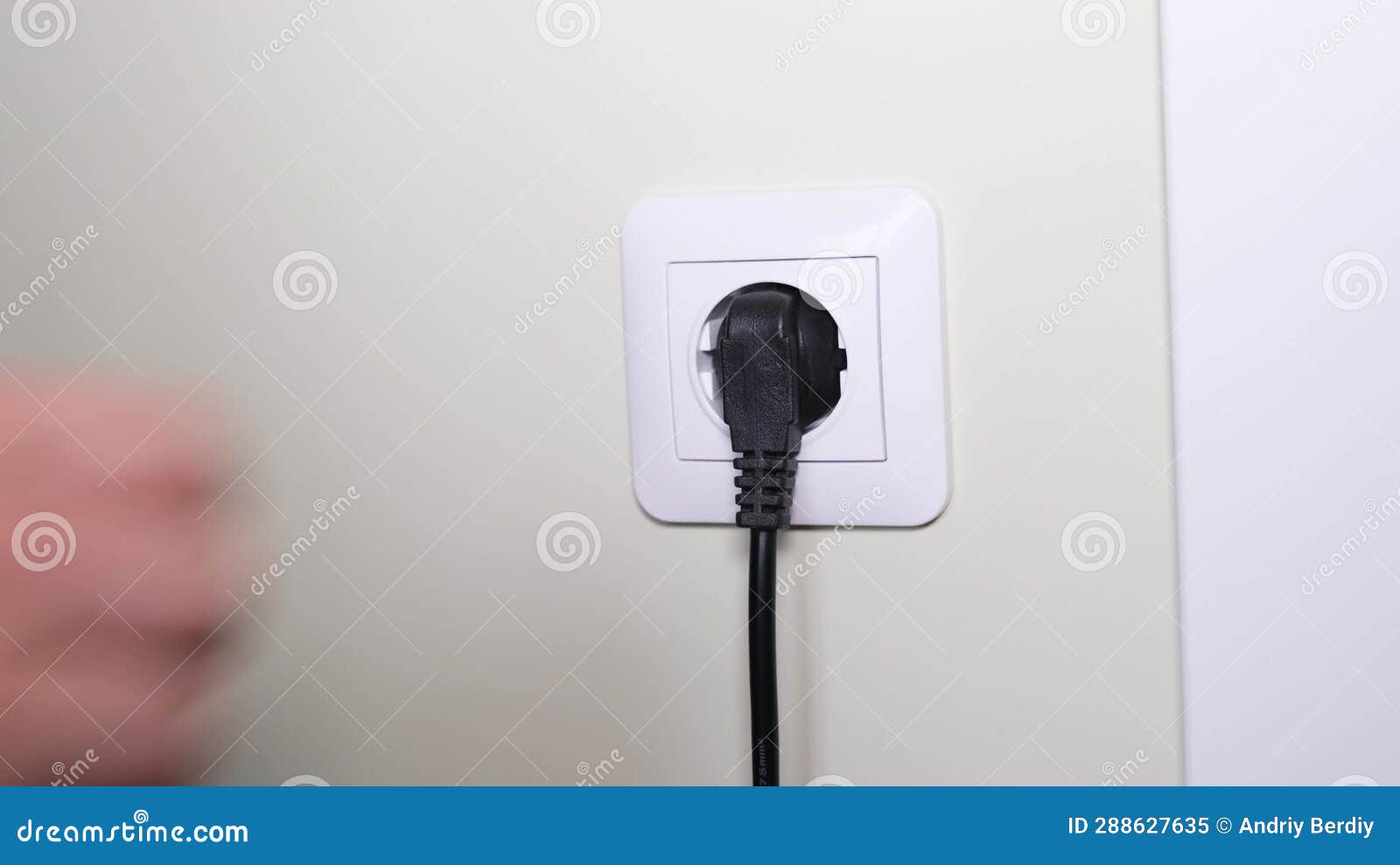A Man S Hand Connecting a Black Power Supply Unit To an Electrical ...