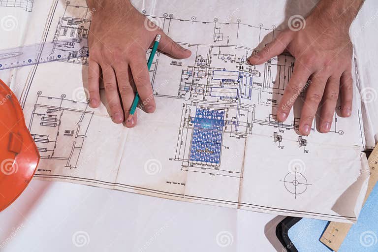 A Man`s Hand Draws a Construction Drawing Stock Photo - Image of helmet ...