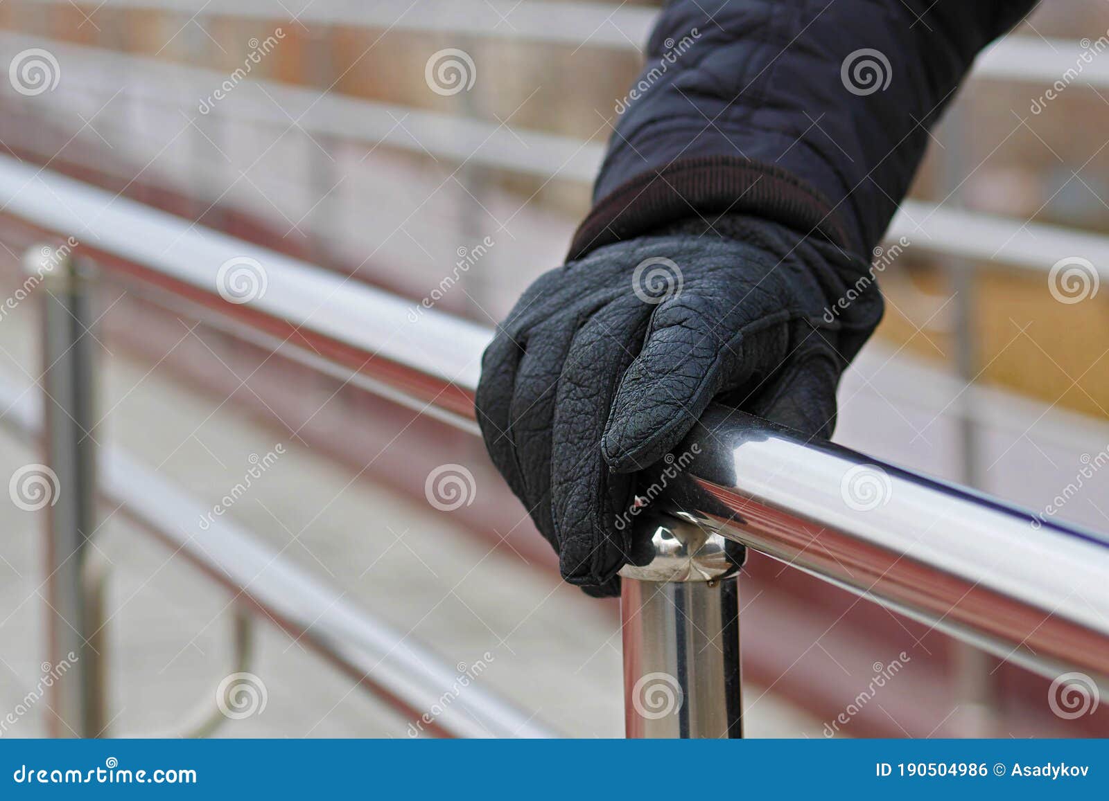 Man`s Hand in Glove Holding Hand Rail while Walking Down Stairs Stock ...