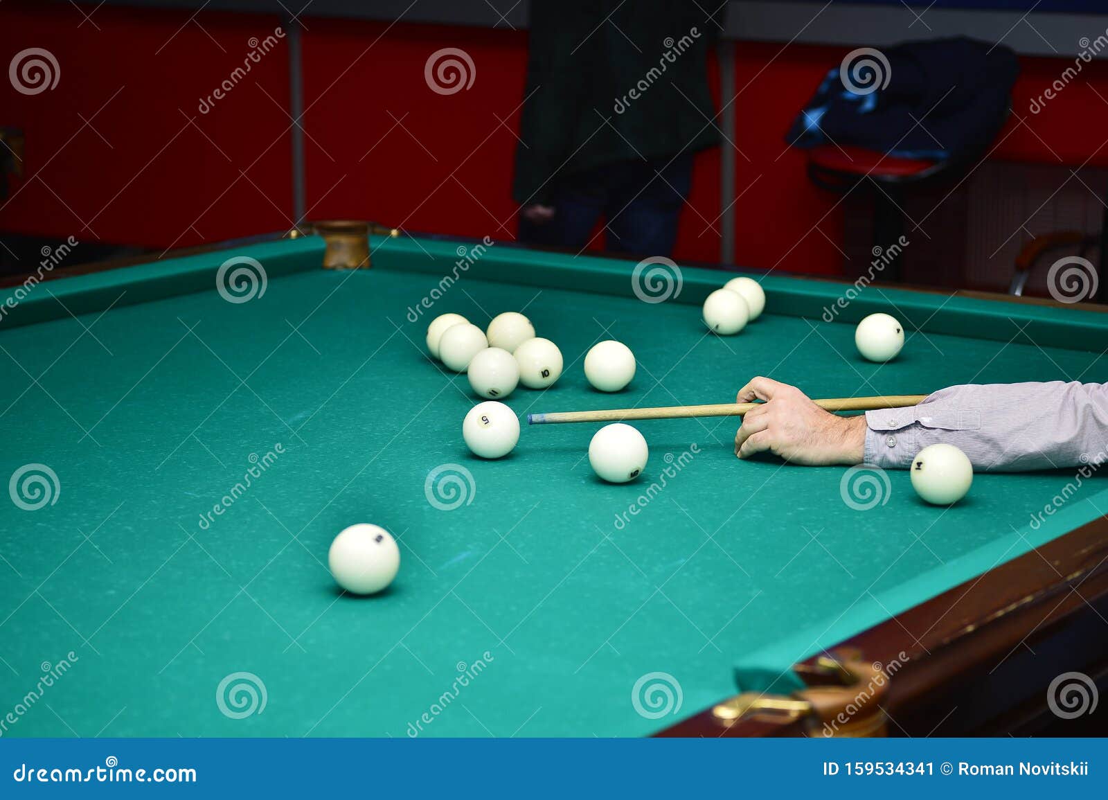 A Man`s Hand Holding a Cue at the Time of Aiming a Billiard Party Stock ...